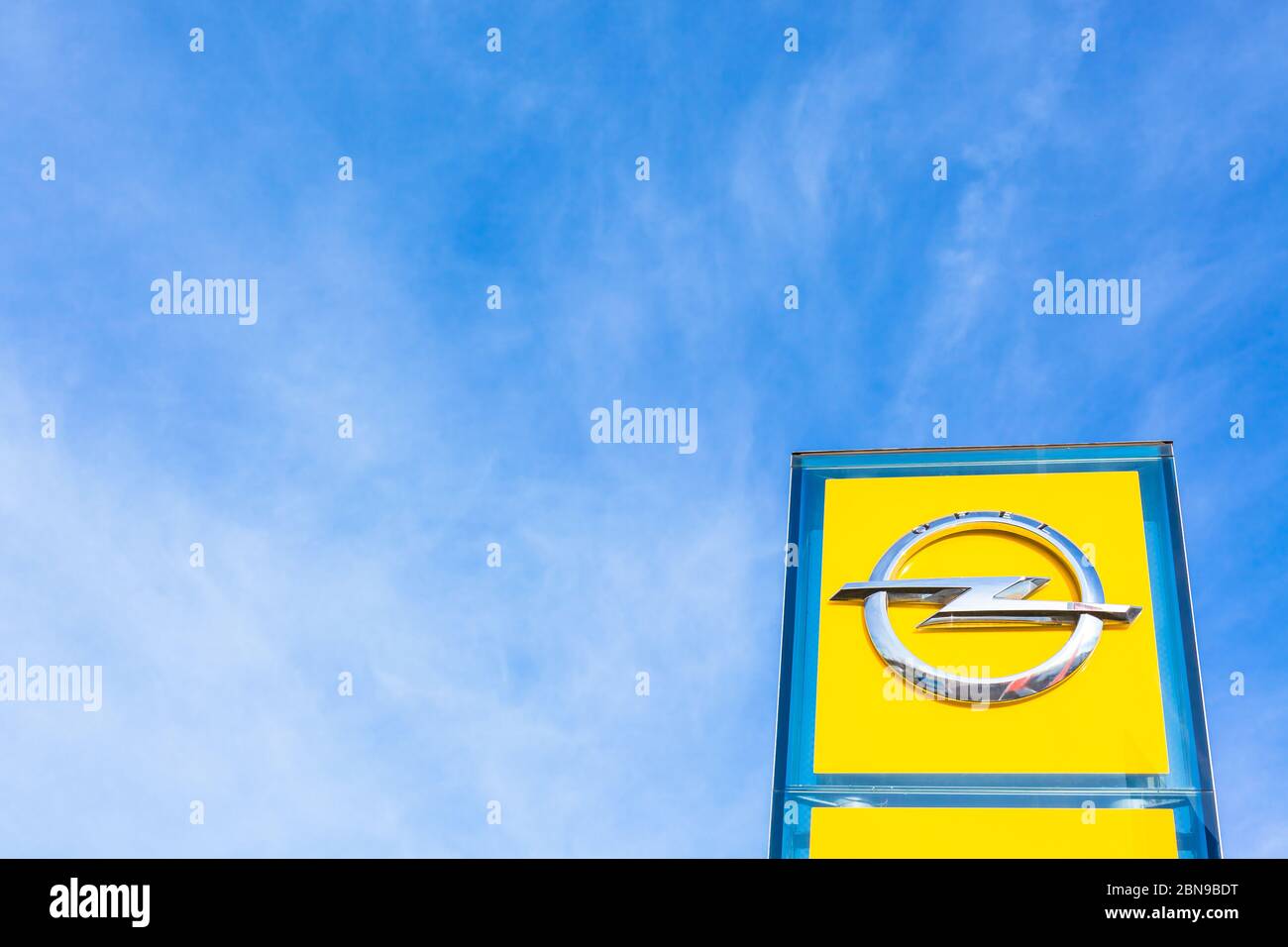 Opel brand logo on bright blue sky background located in Lyon, France ...