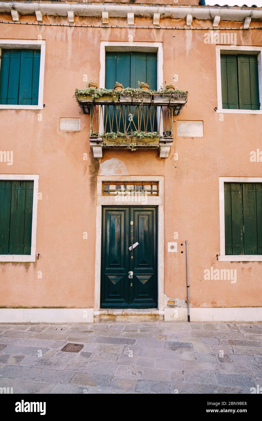 Close-ups of building facades in Venice, Italy. Two-storey peach ...