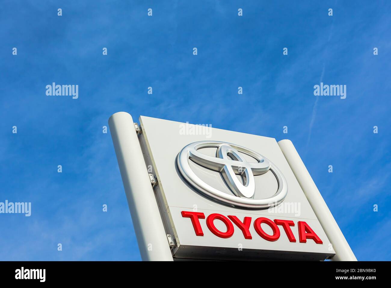 Toyota Motor Corporation brand logo on bright blue sky background ...