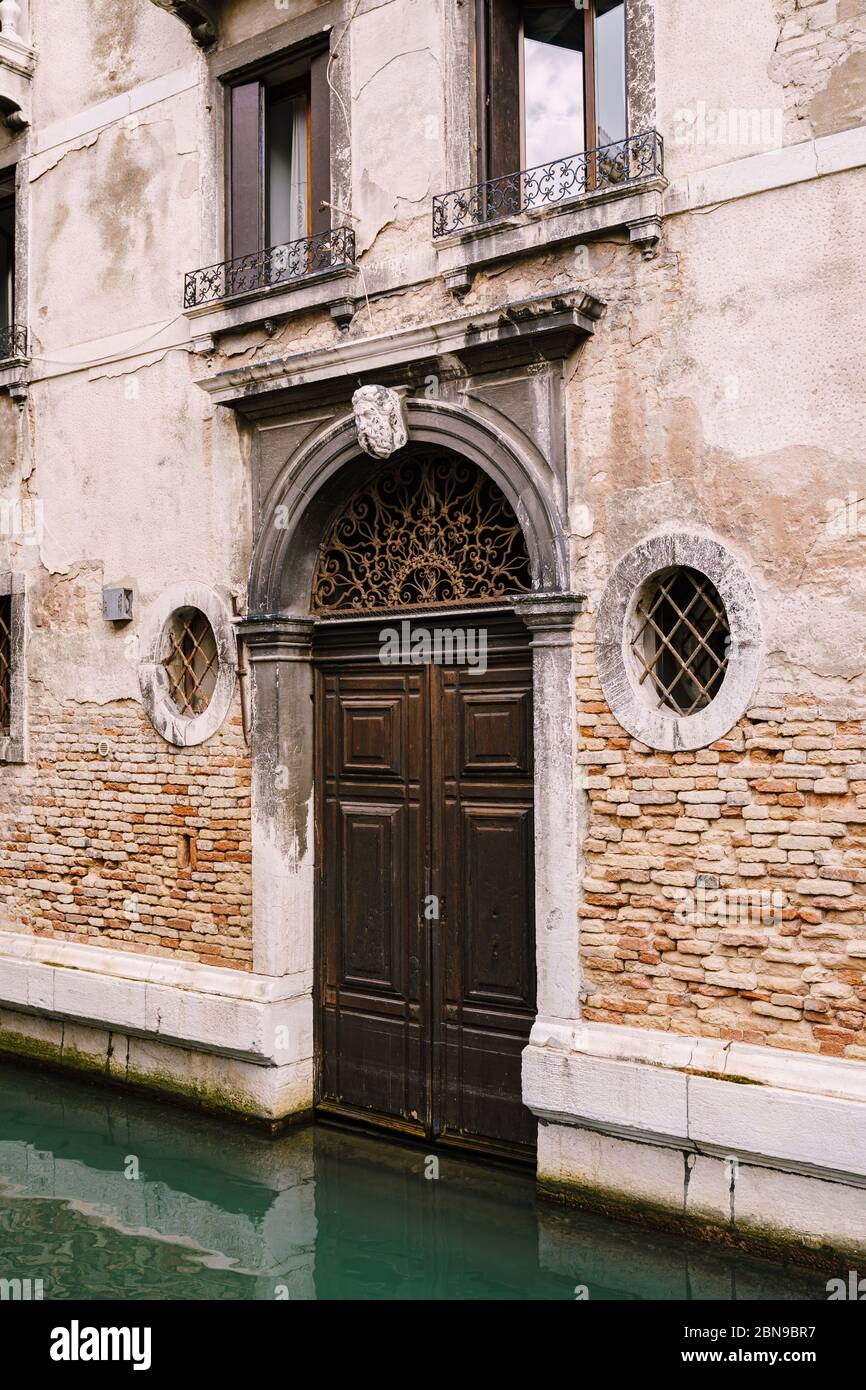 Close-ups of building facades in Venice, Italy. Ancient wooden brown ...