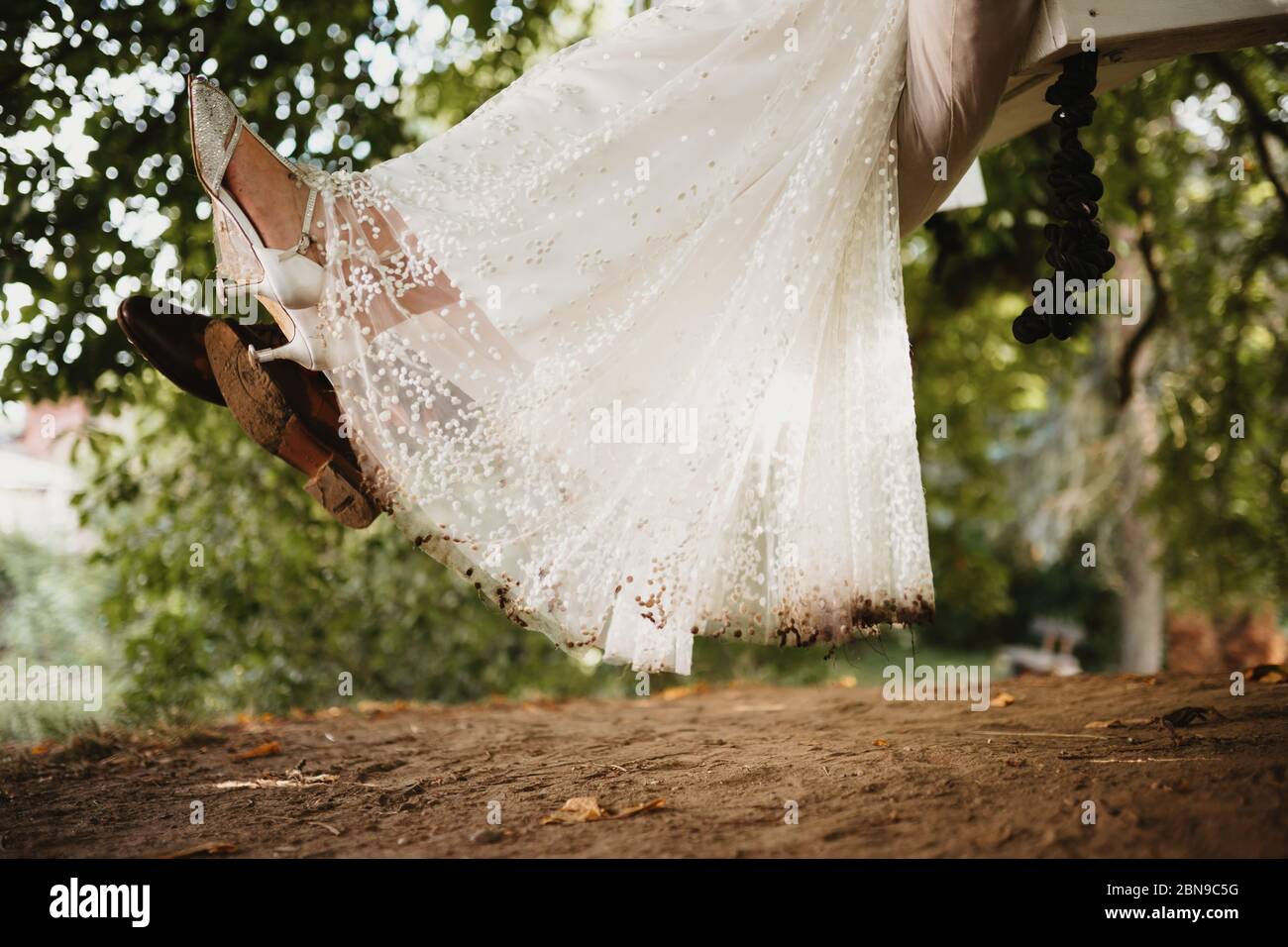 photo of a bride and a groom on a swing Stock Photo - Alamy