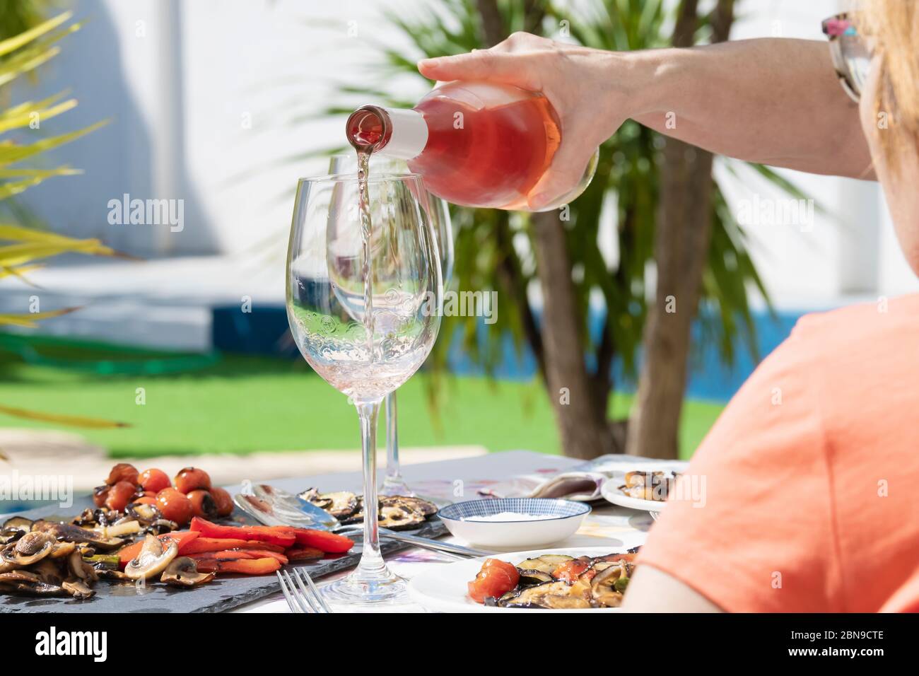 a hand of woman pouring delicious rose wine Stock Photo - Alamy