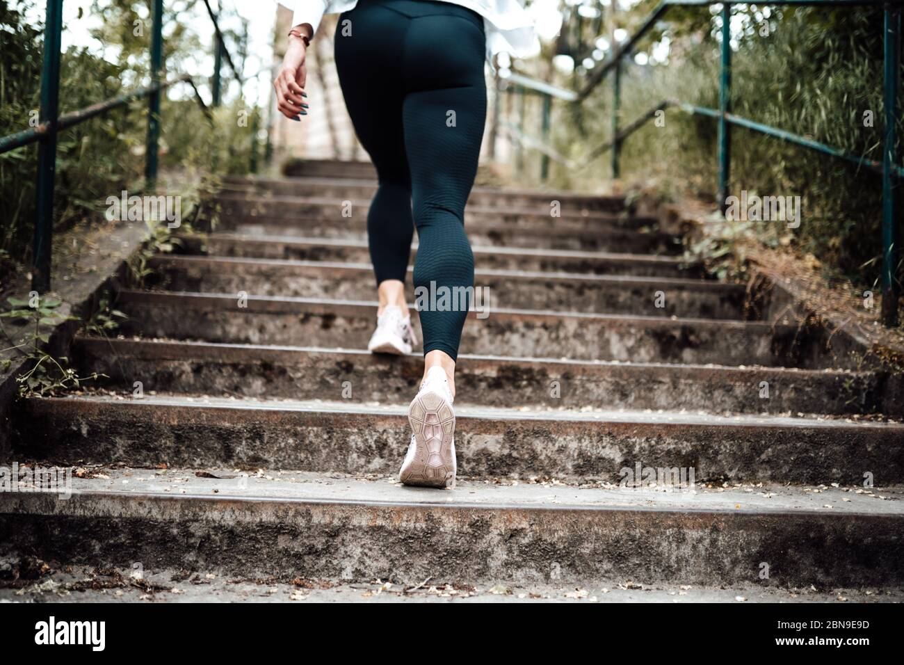 photo of a sport girl going up on stairs Stock Photo - Alamy