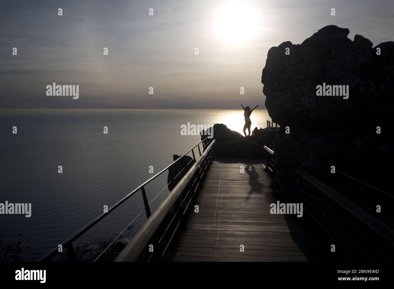 Backlit woman posing on Table Mountain, South Africa Stock Photo - Alamy