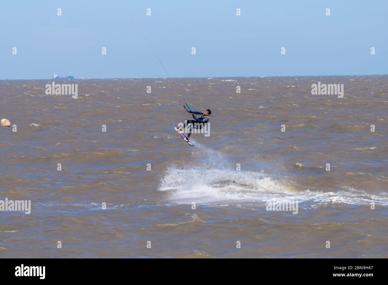 A kite surfer working the wind and surf of the English Channel off the ...