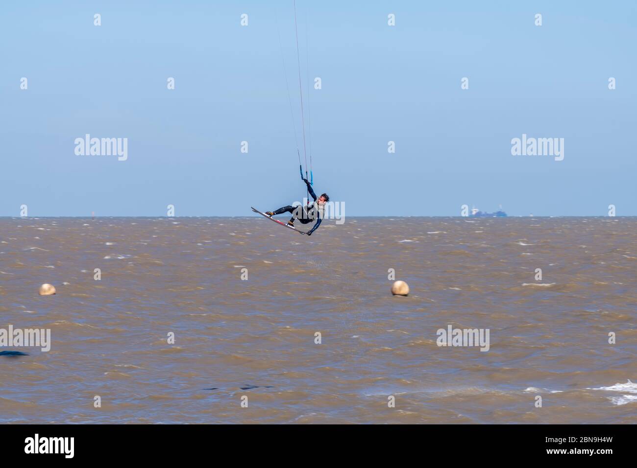 A kite surfer working the wind and surf of the English Channel off the ...