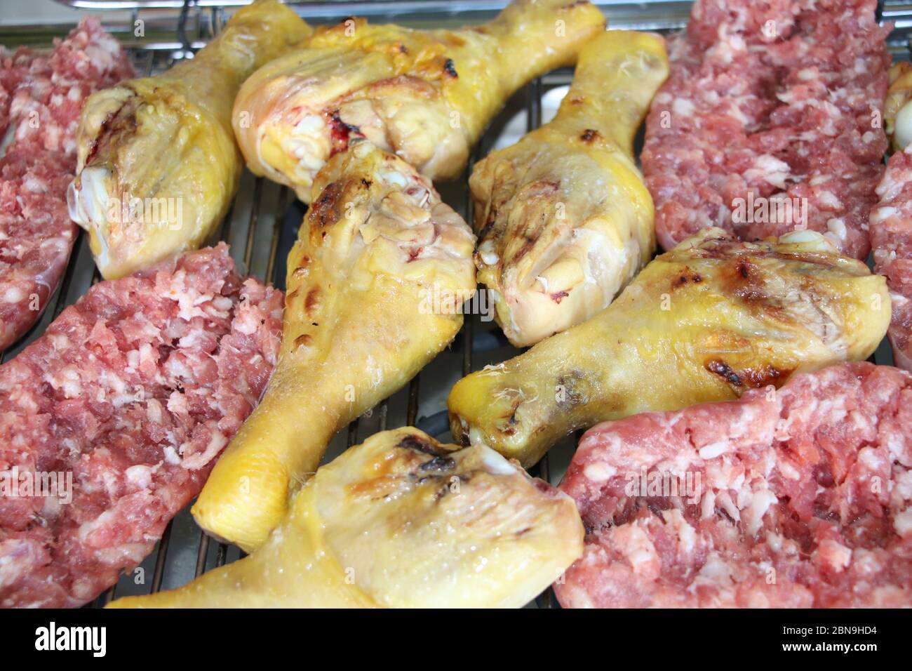 mixed grill with chicken and sausage cooked at barbecue Stock Photo - Alamy