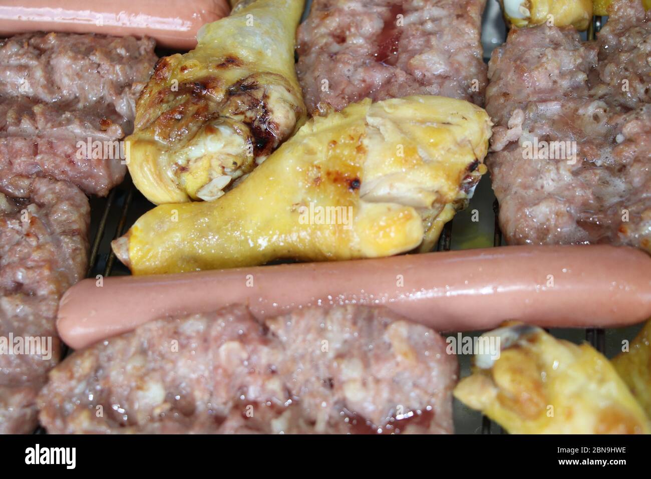 mixed grill with chicken and sausage cooked at barbecue Stock Photo - Alamy