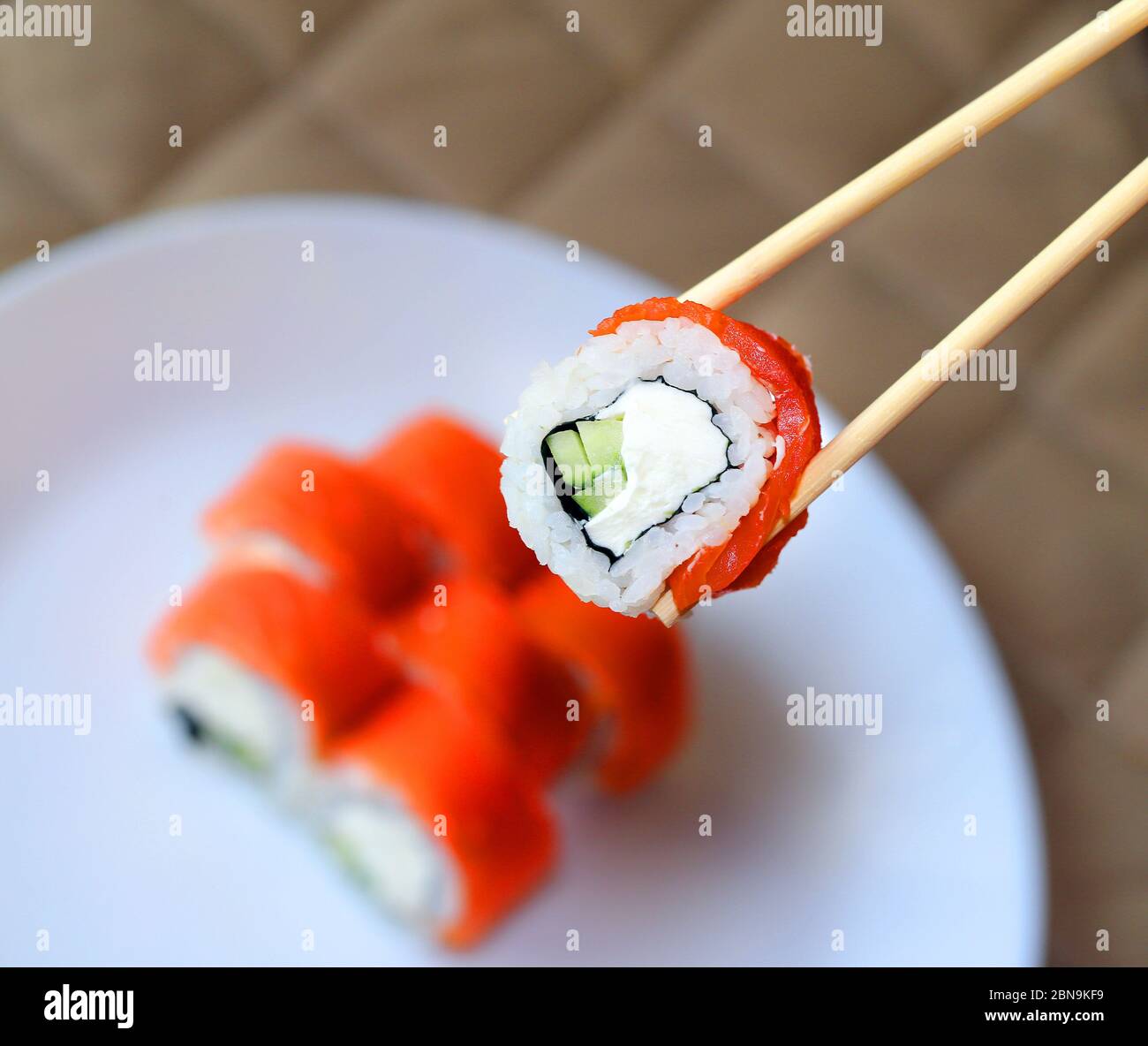 Photo of a fish roll with chopsticks for lunch Stock Photo - Alamy
