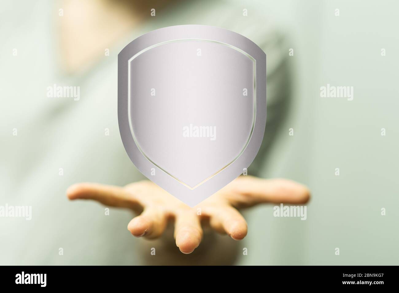 A shield protection concept holding in hand Stock Photo - Alamy