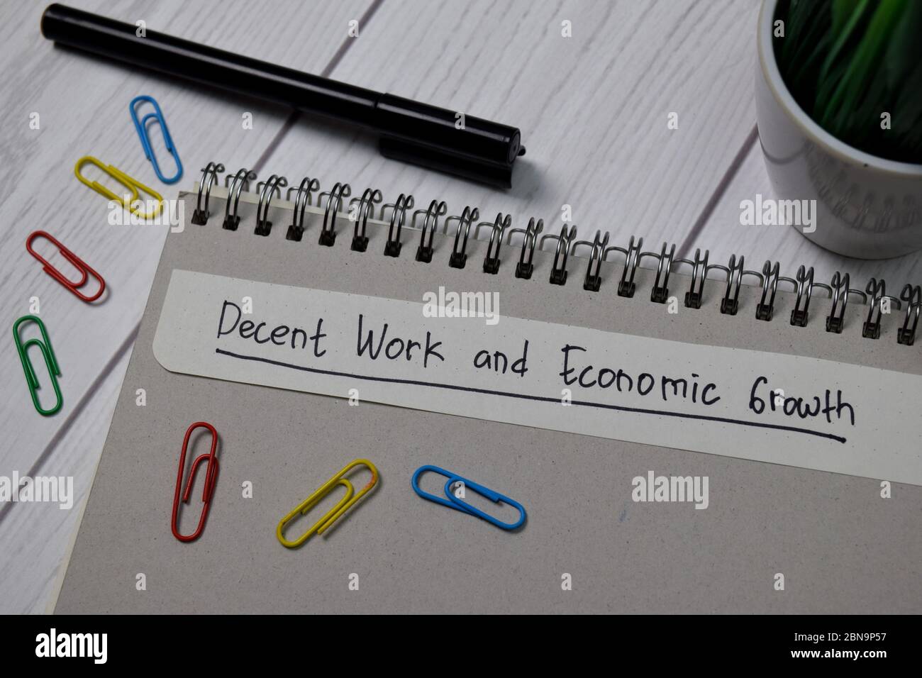 Decent Work and Economic Growth write on sticky notes isolated on ...