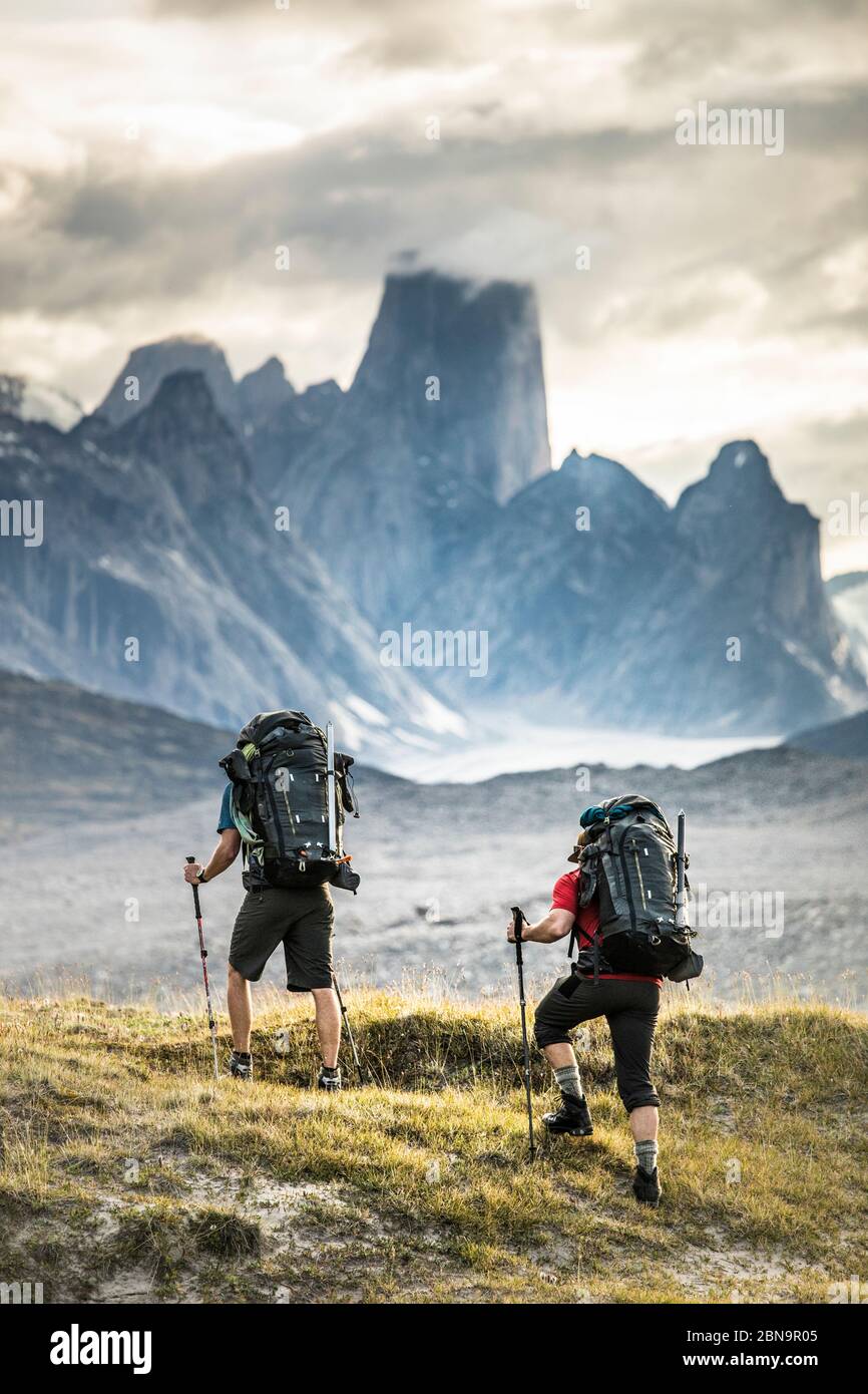 Two climbers hike toward Mount Asgard in Akshayak Pass Stock Photo - Alamy