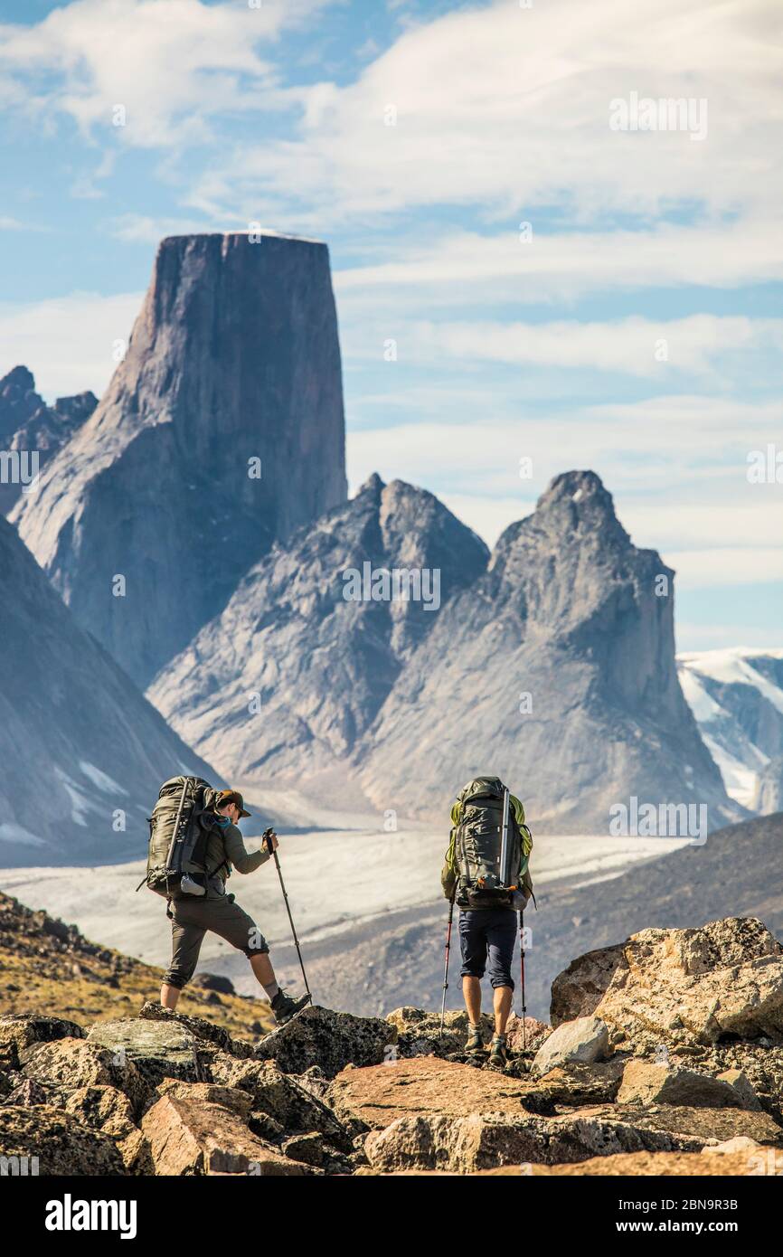 Two climbers approach Mount Asgard, Akshayak Pass, Baffin Island Stock ...