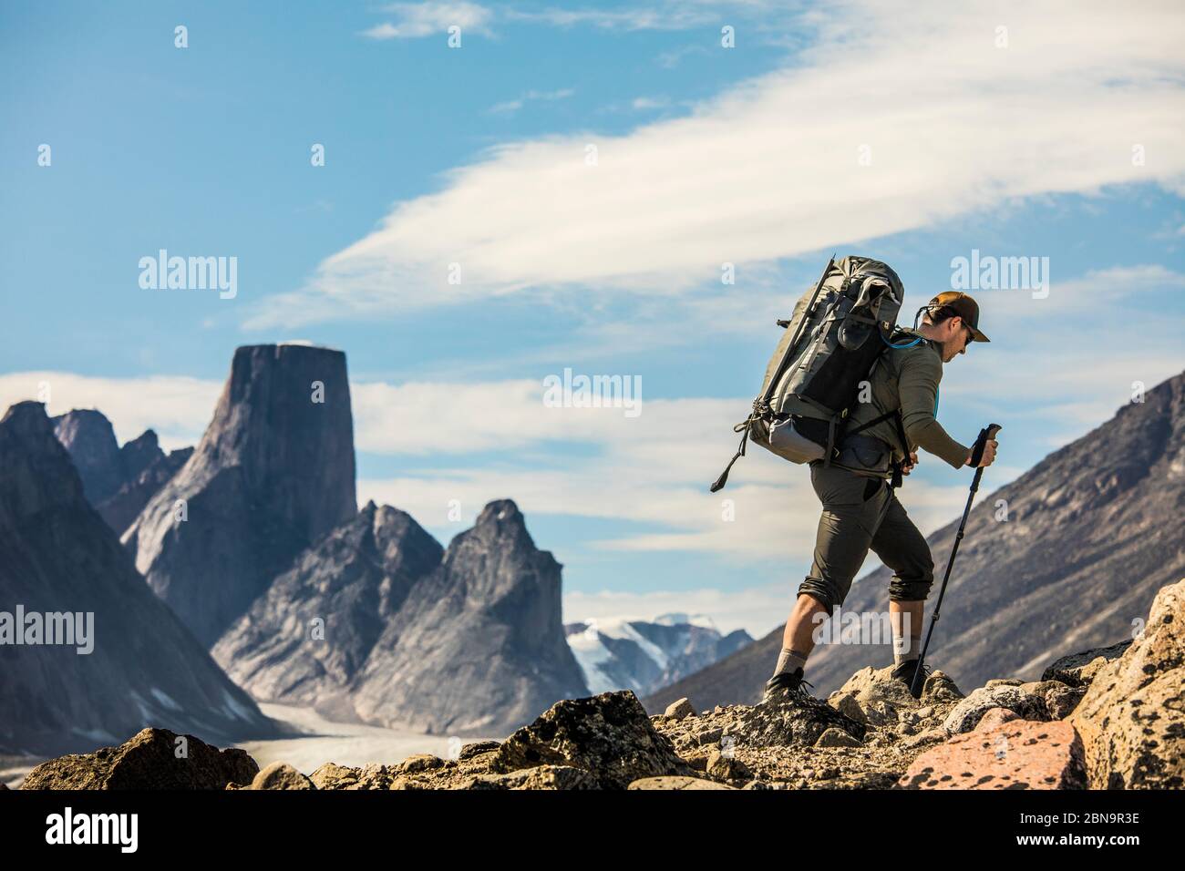Backpacker on the move on rugged mountain ridge Stock Photo - Alamy
