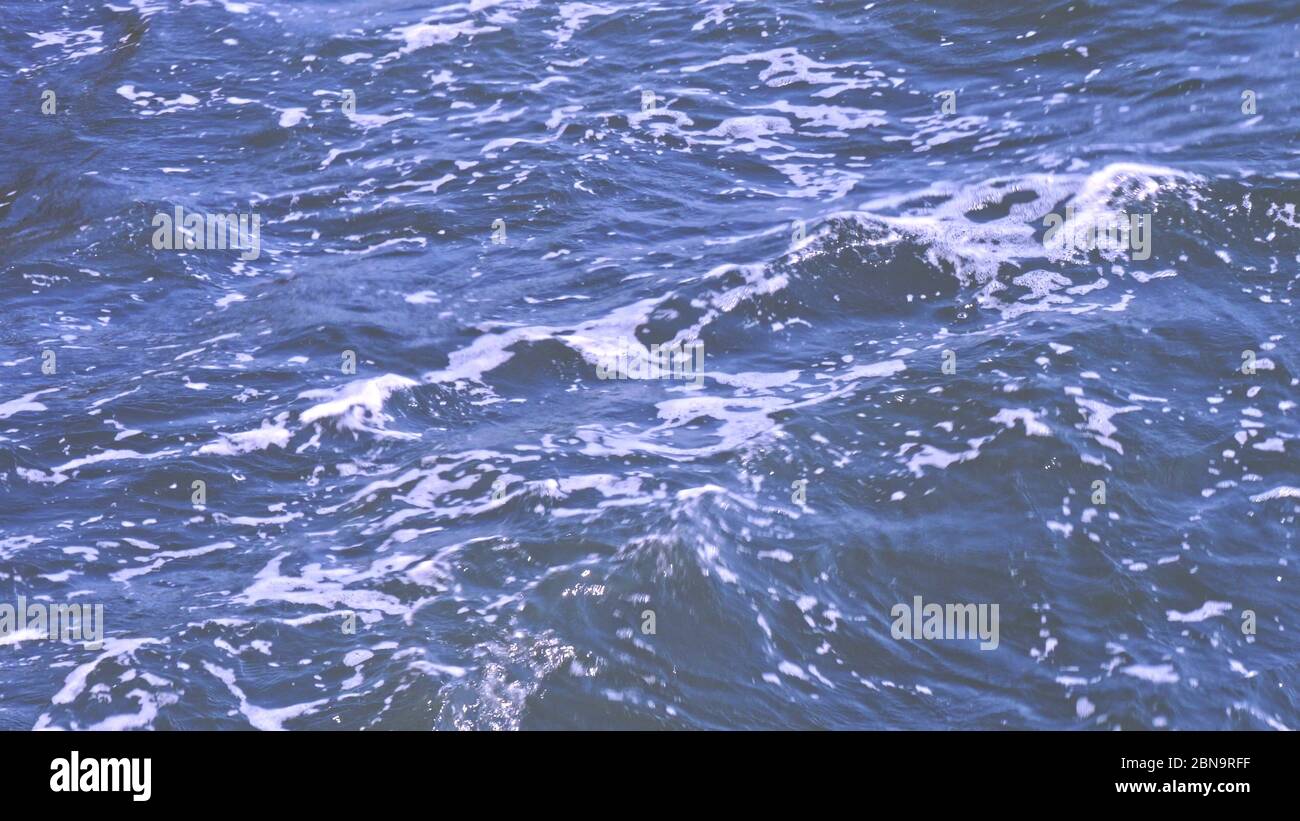 Waves with ripples on the surface of the sea water background texture ...