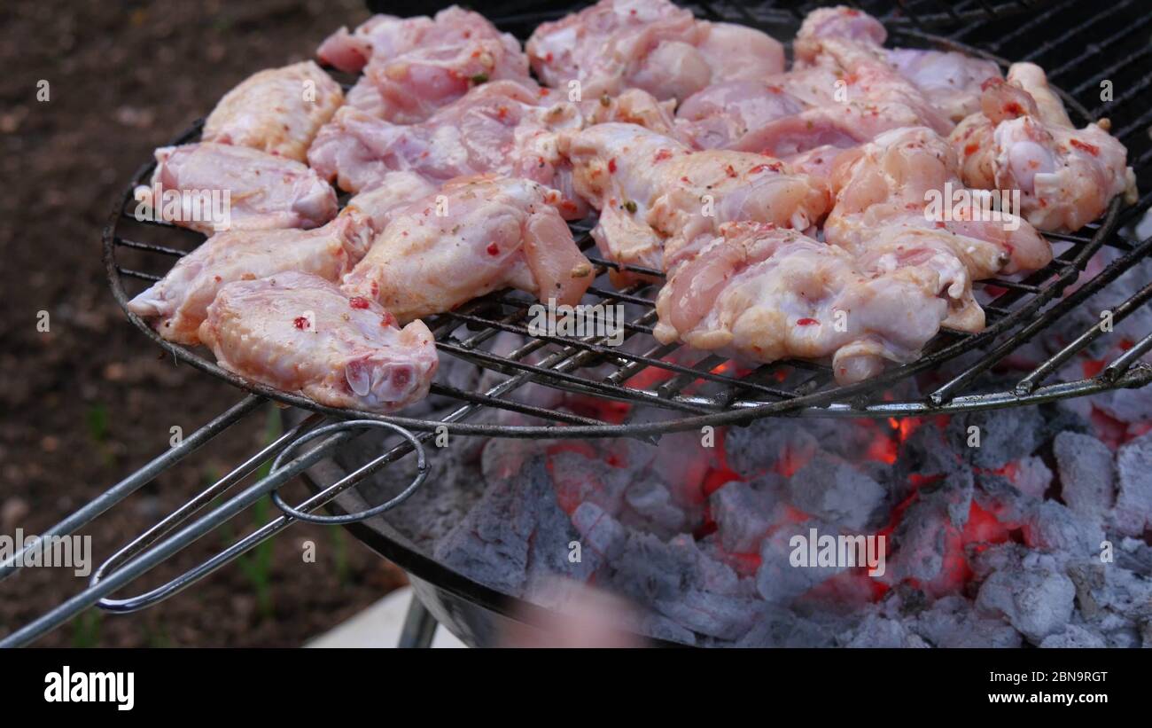 Chicken meat cooking on a barbecue grill Stock Photo - Alamy
