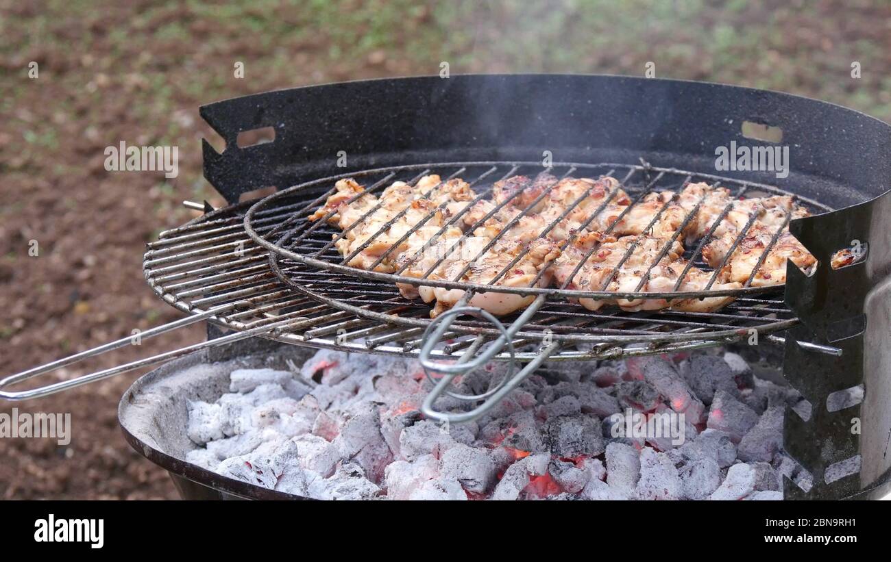 Chicken meats are grilled on charcoal barbecue. Outdoor grill Stock ...