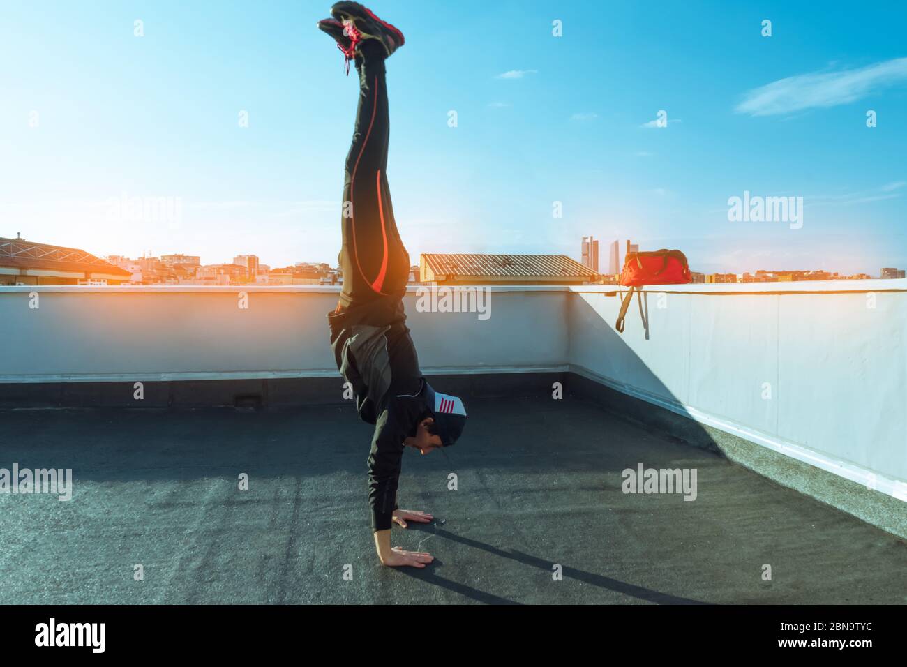 Boy doing a handstand on a terrace Stock Photo - Alamy
