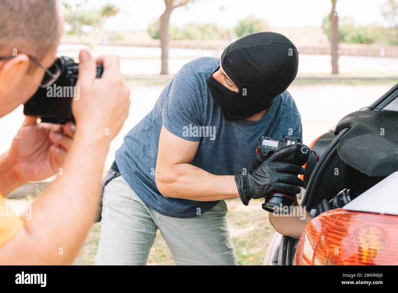 Photographer taking a picture of a robber stealing a camera Stock Photo ...