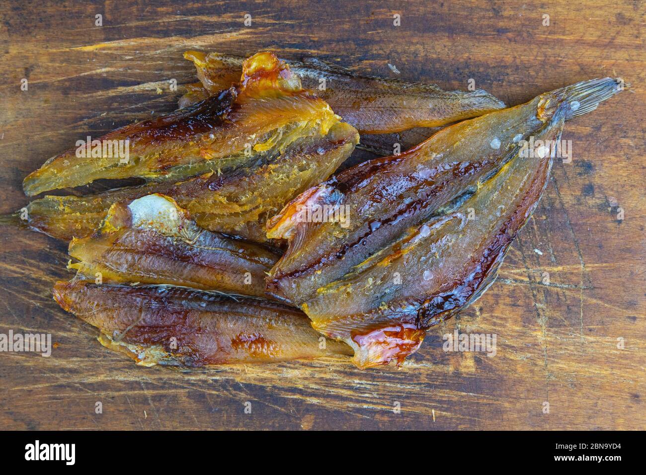 Dried blue whiting fish on wooden background. Snack to beer. Close up ...