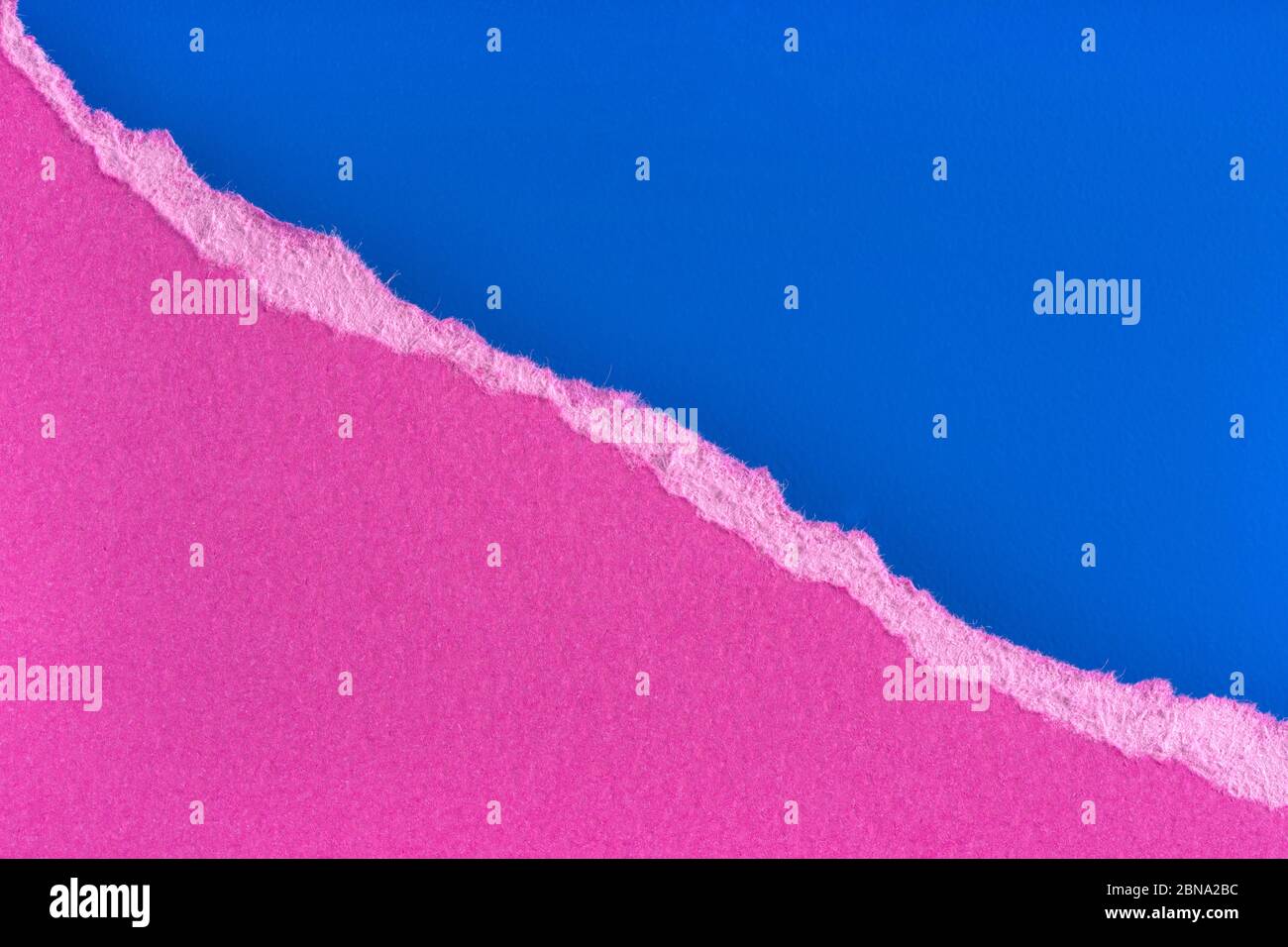 Torn purple paper edge on blue background. Ripped paper piece edge ...