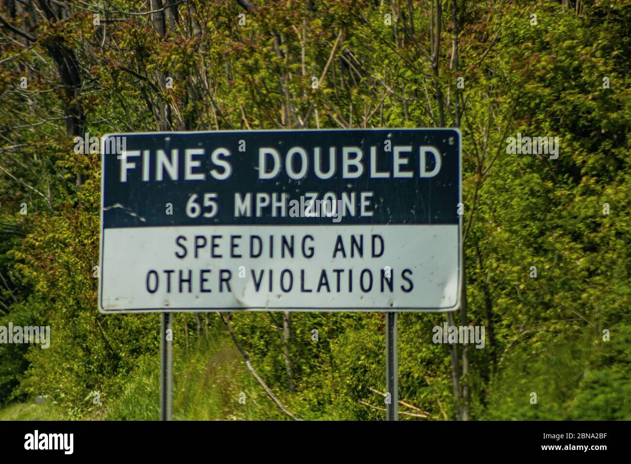 Fine doubles 65 MPH zone sign Stock Photo - Alamy