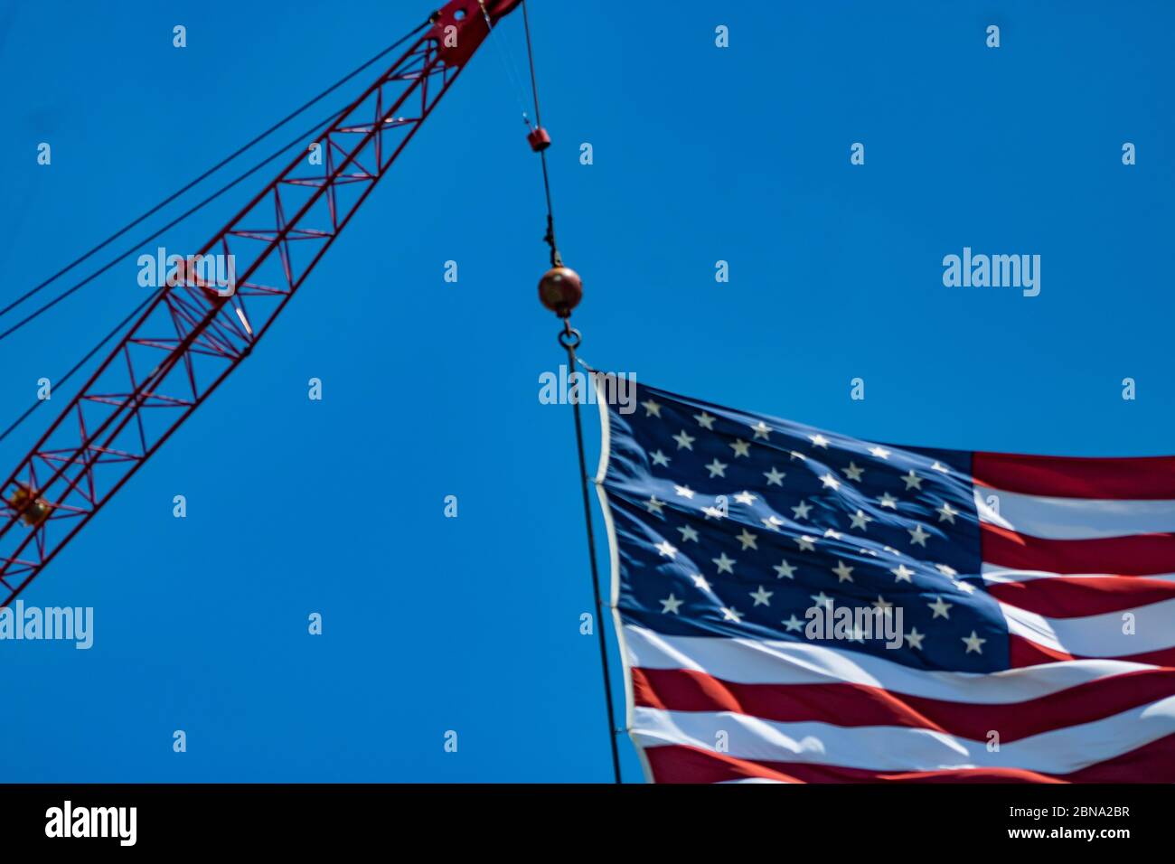 American flag hanging from crane hi-res stock photography and images ...