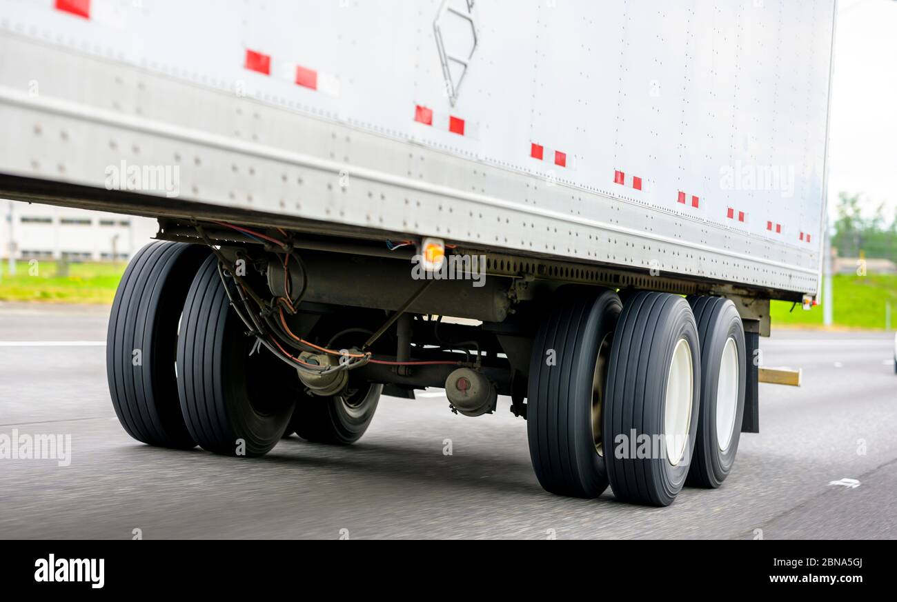 Powerful big rig semi truck transporting loaded commercial cargo in ...