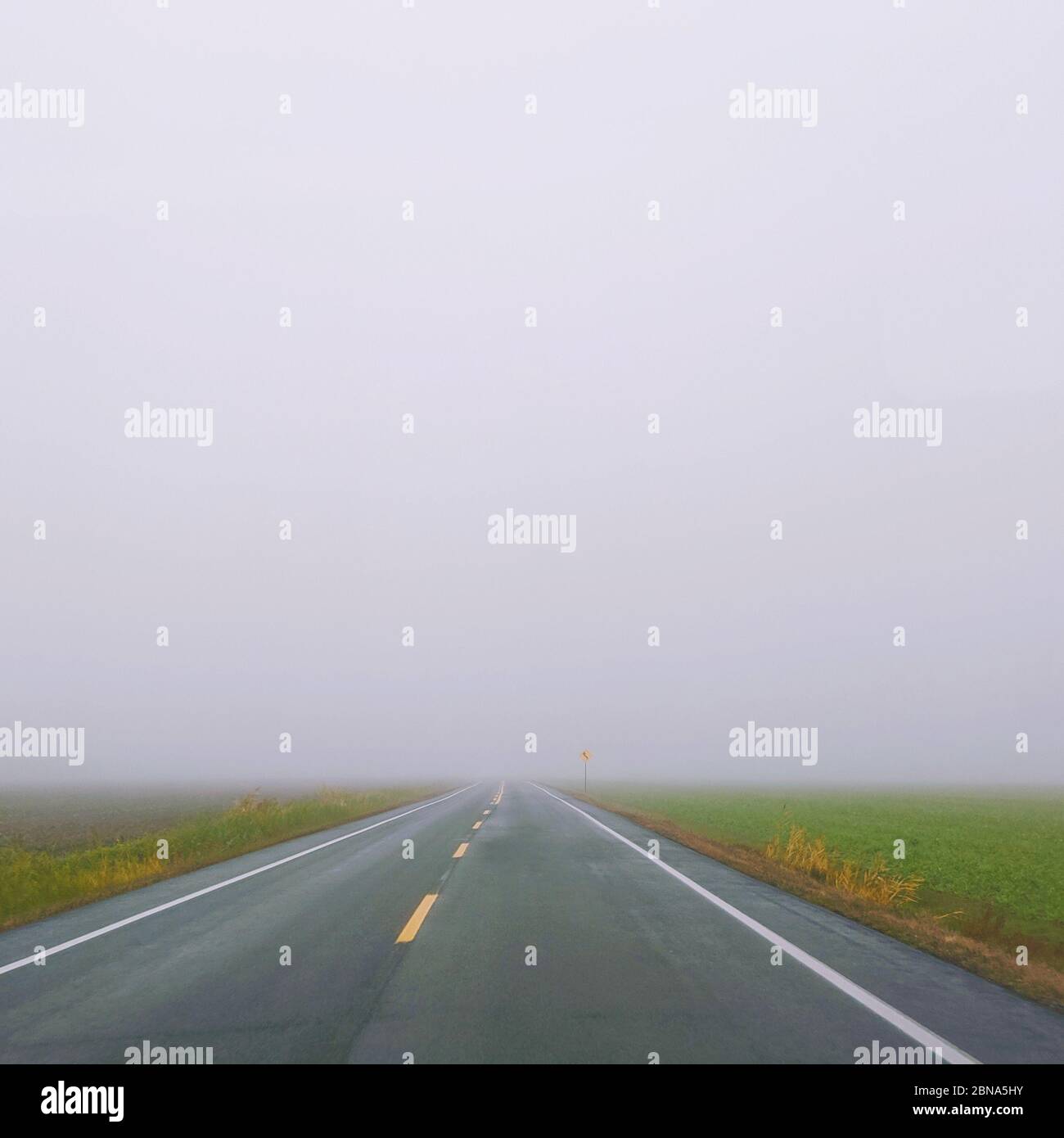 on the road with fog Stock Photo - Alamy