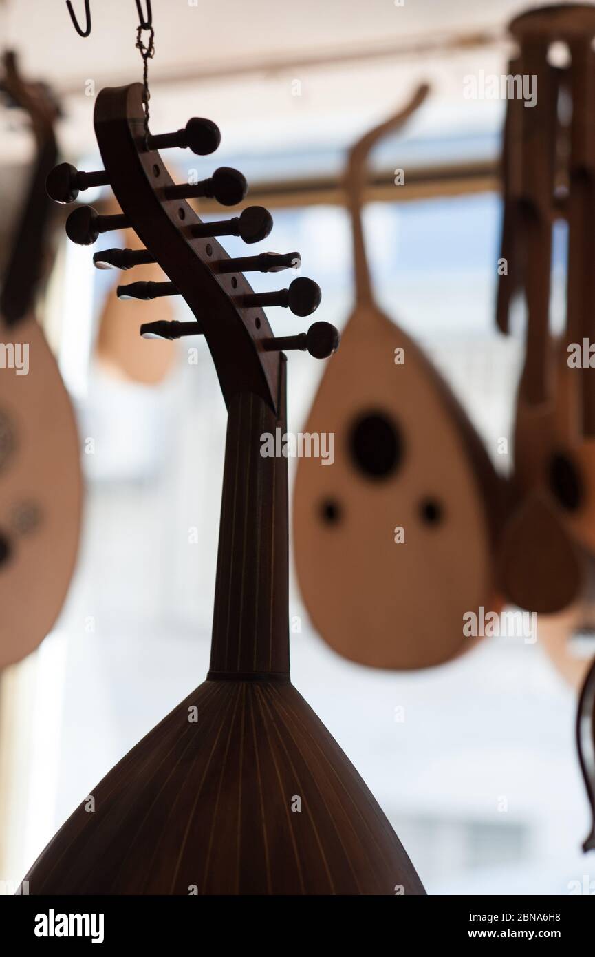 Vertical closeup shot of an oud musical instrument neck with other ...