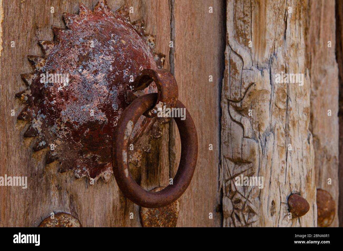 Closeup shot of the rusty door handle installed on a wooden door Stock ...