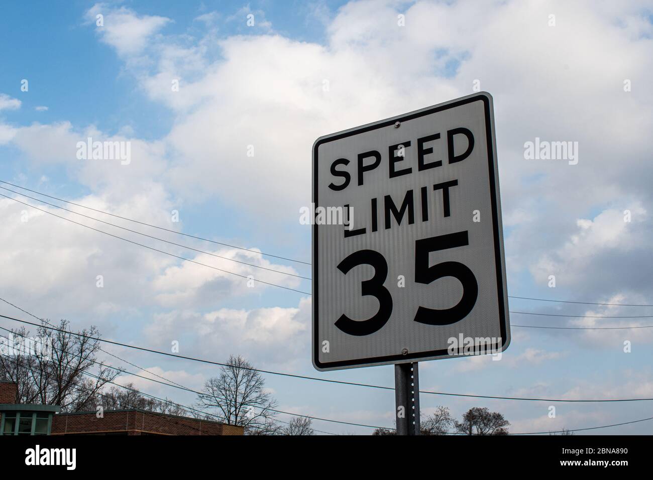 Closeup low angle shot of Speed Limit sign with 35 on it under a cloudy ...