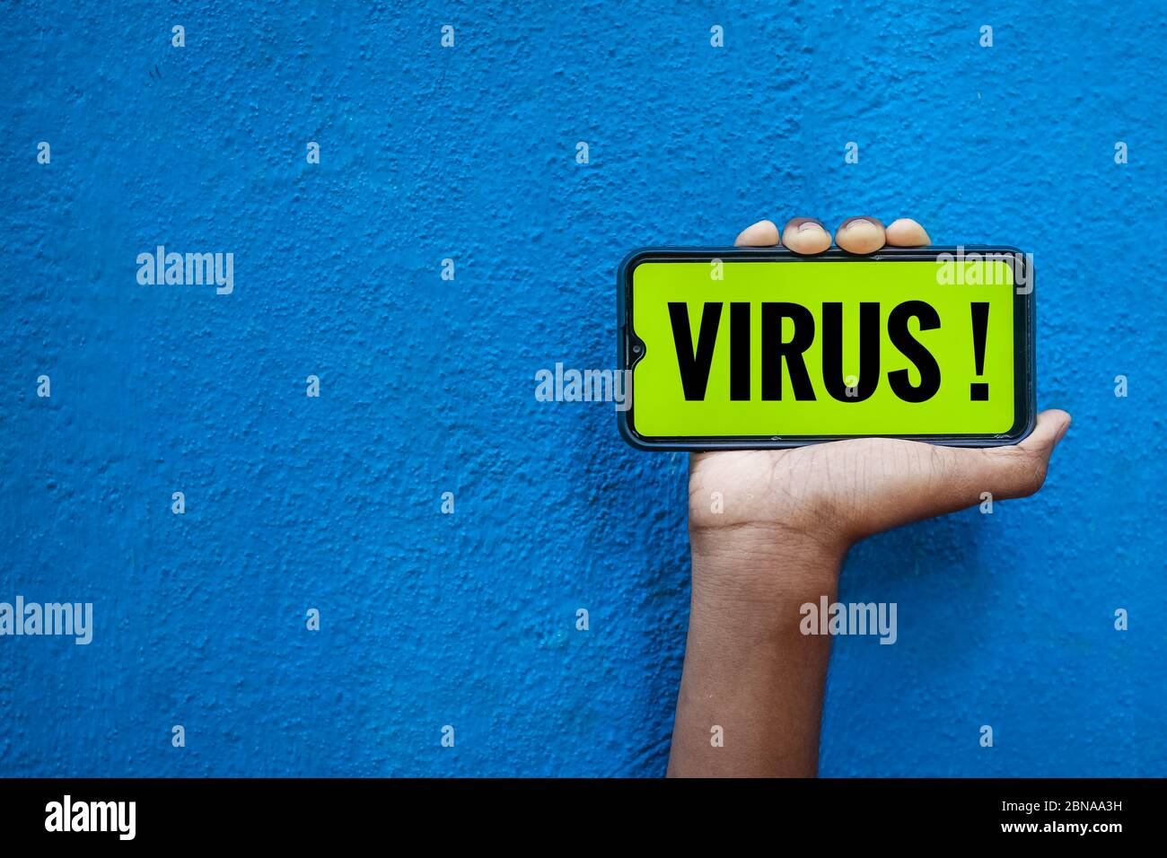 Virus / Covid-19 wording on smart phone screen isolated on blue ...
