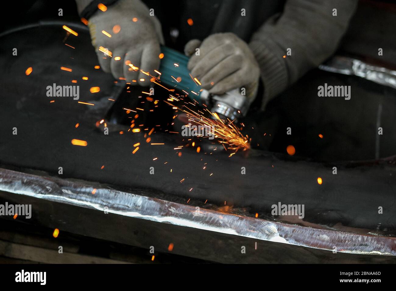 Master grind metal a grinder sparks Stock Photo - Alamy