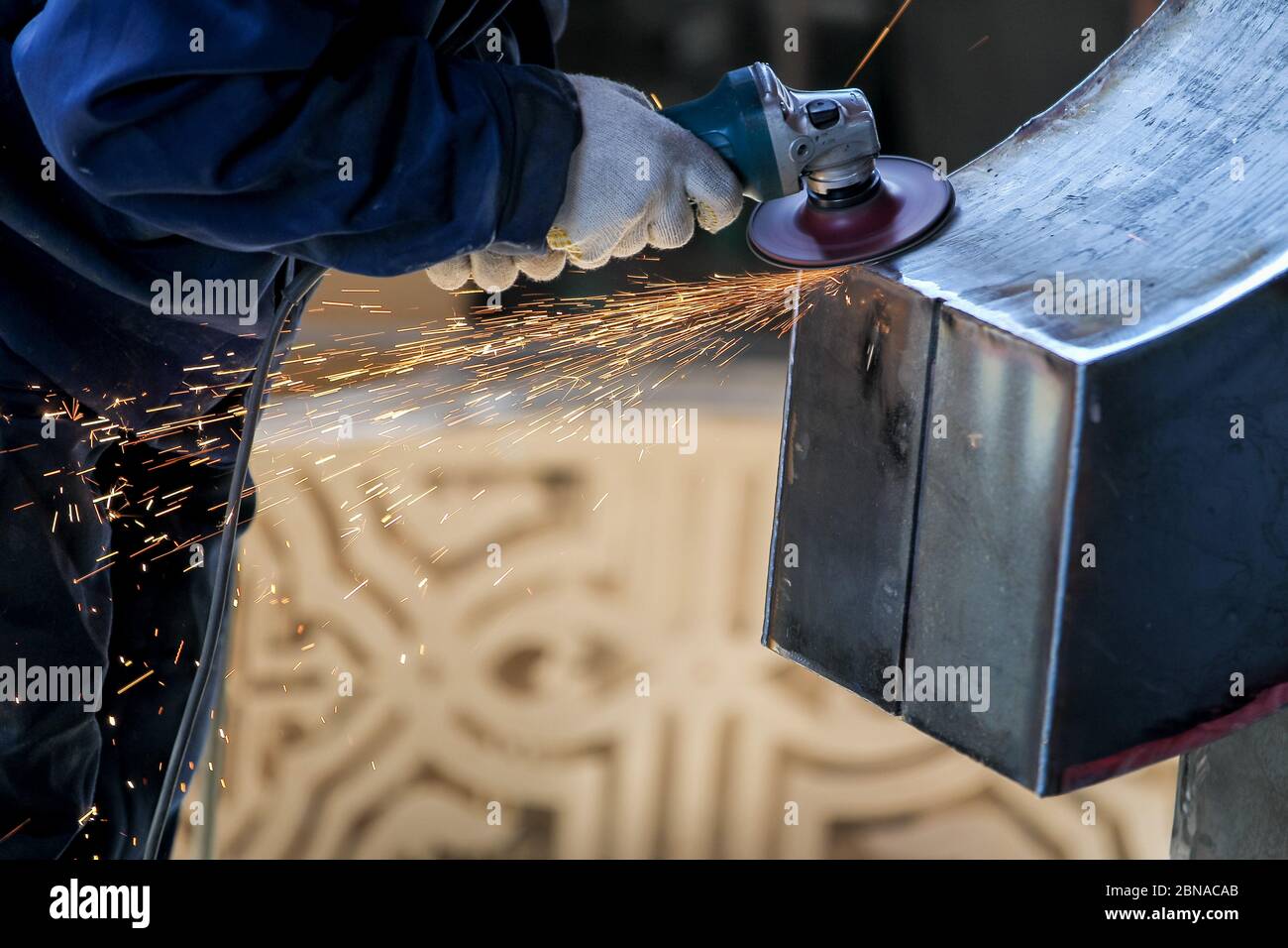 Master grind metal a grinder sparks Stock Photo - Alamy