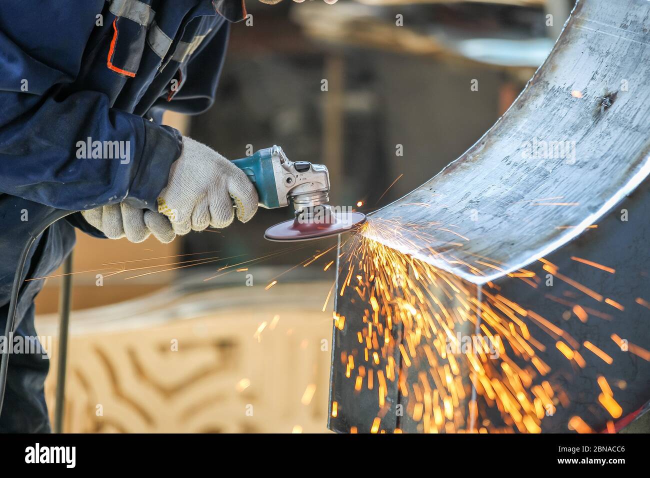 Master grind metal a grinder sparks Stock Photo - Alamy