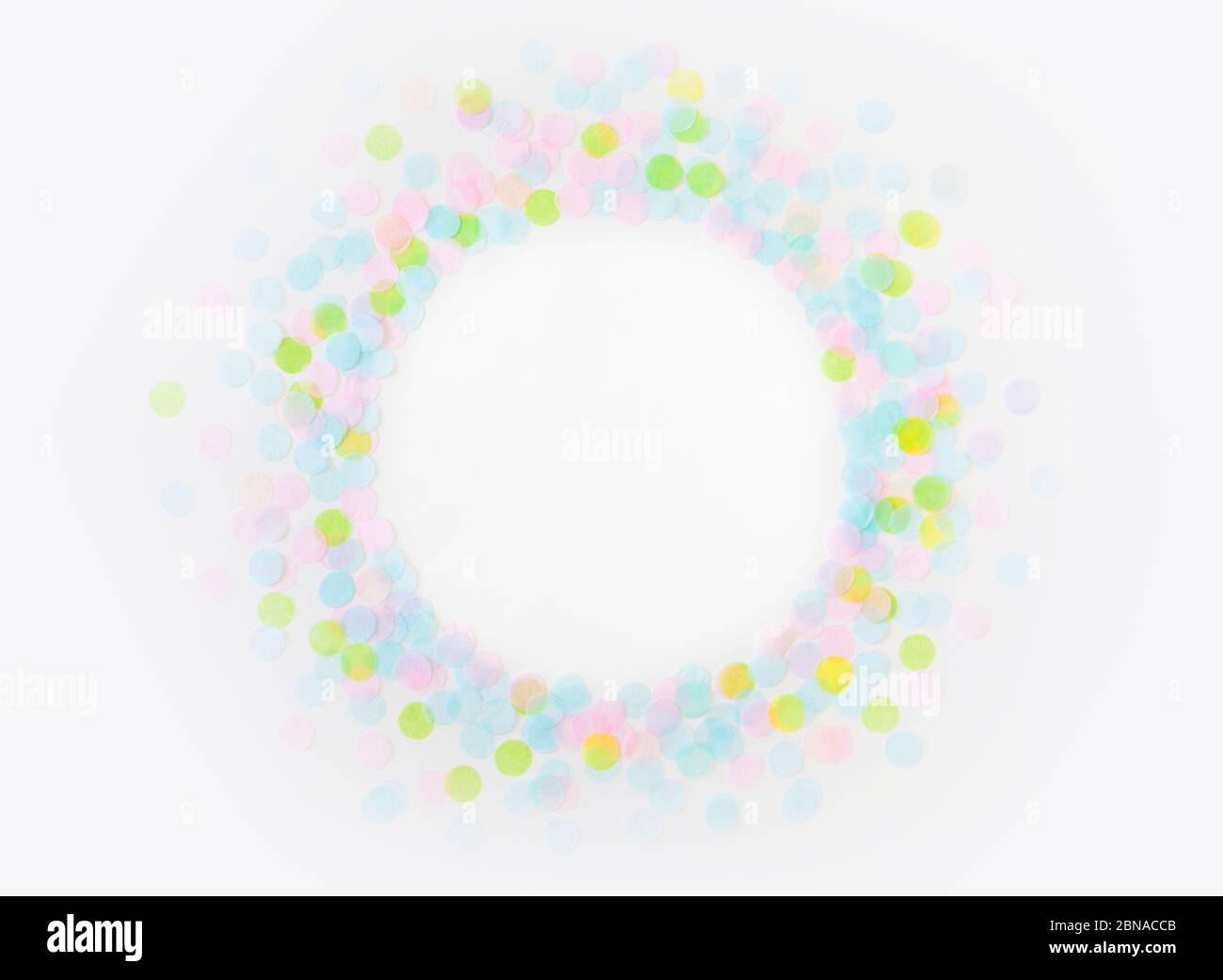 Round frame made of pastel colored confetti. White background. Festive ...