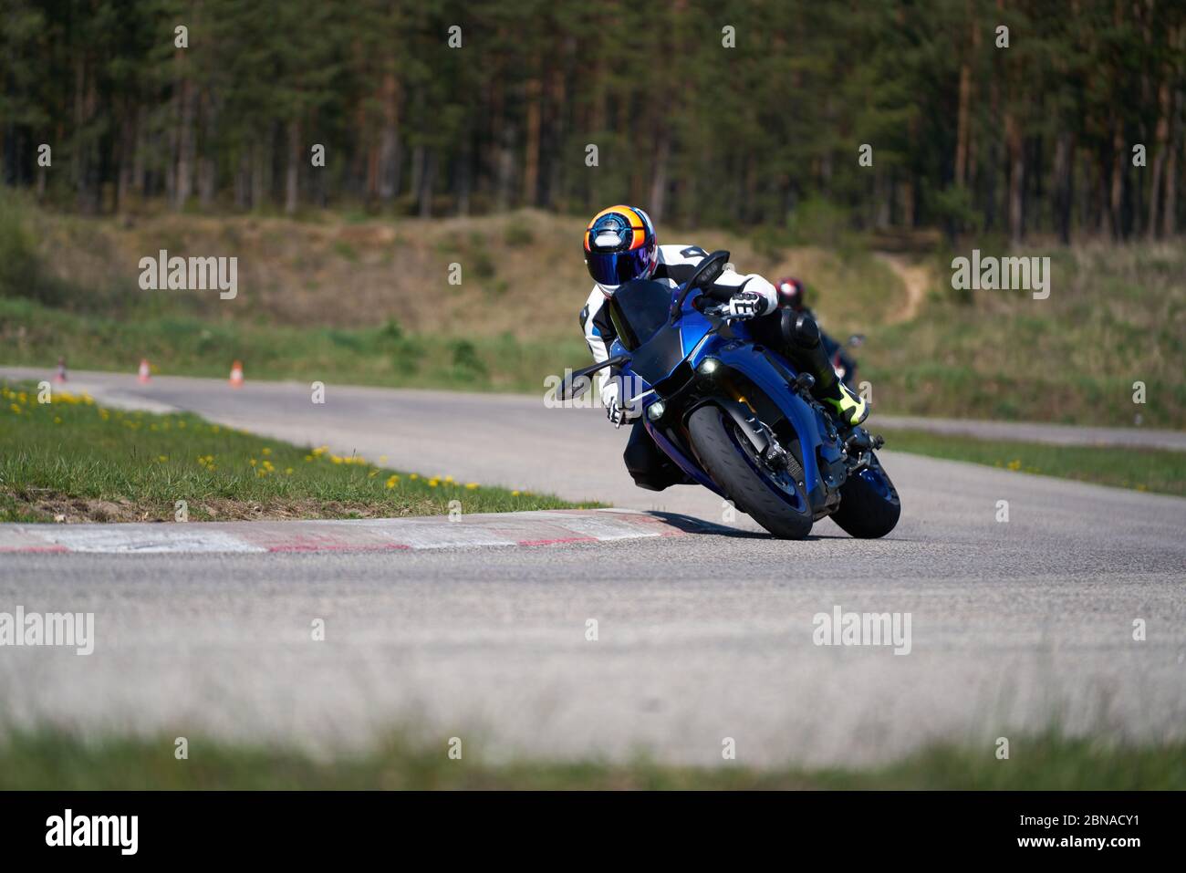 Motorcycle practice leaning into a fast corner on track Stock Photo - Alamy