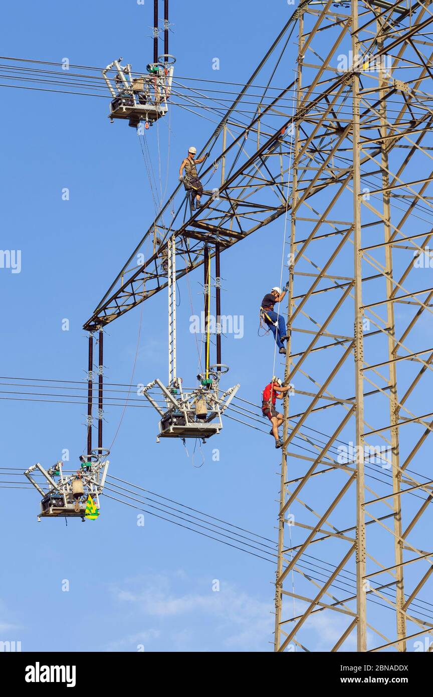 High voltage engineers working on the high voltage pylon, Baden ...