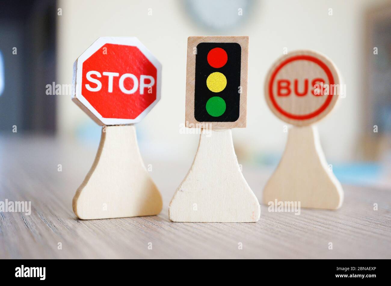 Wooden toy street signs: "Stop", "Bus", "traffic light", placed on the ...