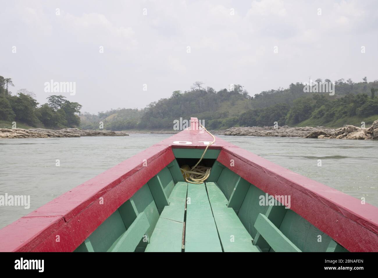 Beautiful scene of a small boat in the river with the forest in the ...