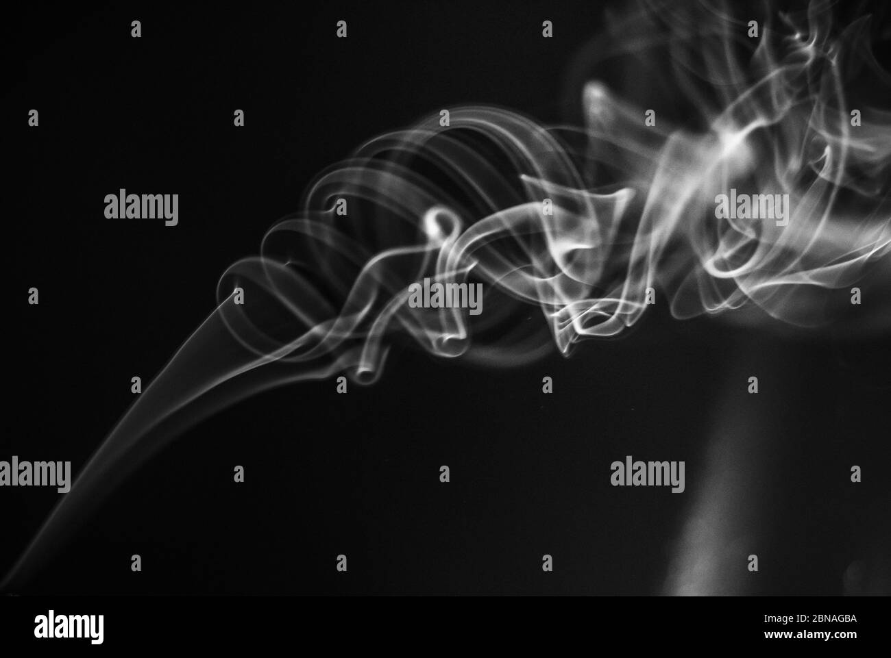 Beautiful shot of spiral smoke with black background Stock Photo - Alamy