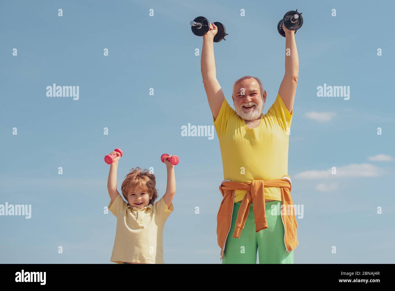 Grandfather and child in gym working out with weights. Portrait of a ...