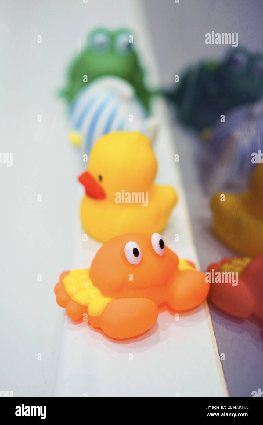 Plastic bathing toys on a bathtub Stock Photo - Alamy