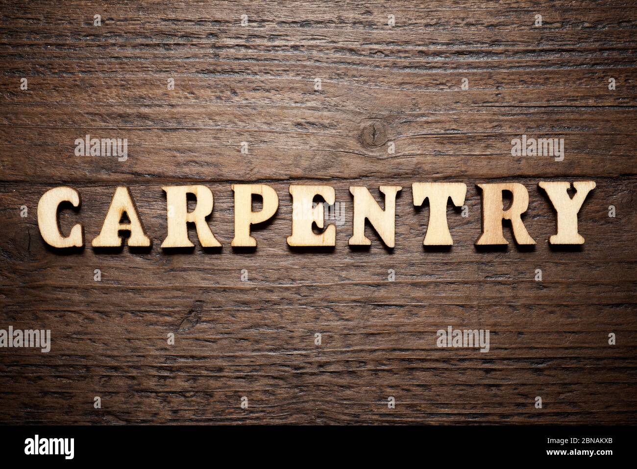Carpentry word on a wood table Stock Photo - Alamy