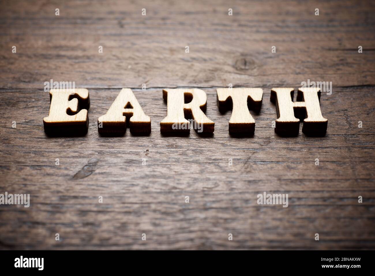Earth word on a wood table Stock Photo - Alamy