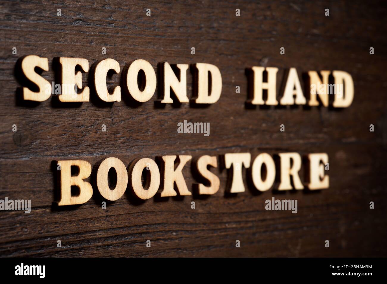 Second hand bookstore text on a wood table Stock Photo - Alamy