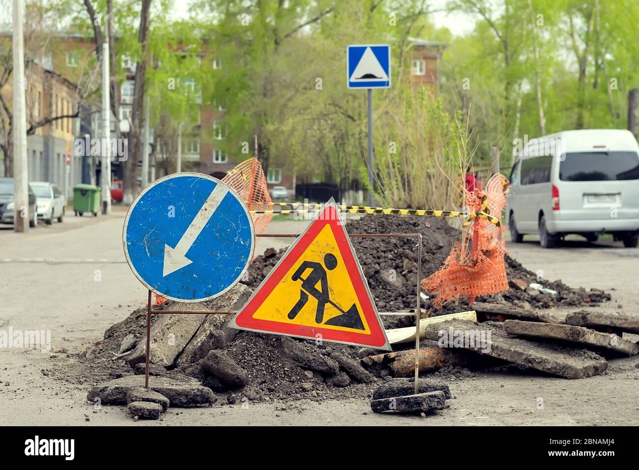 road sign, detour, road repair on the background of the road and broken ...
