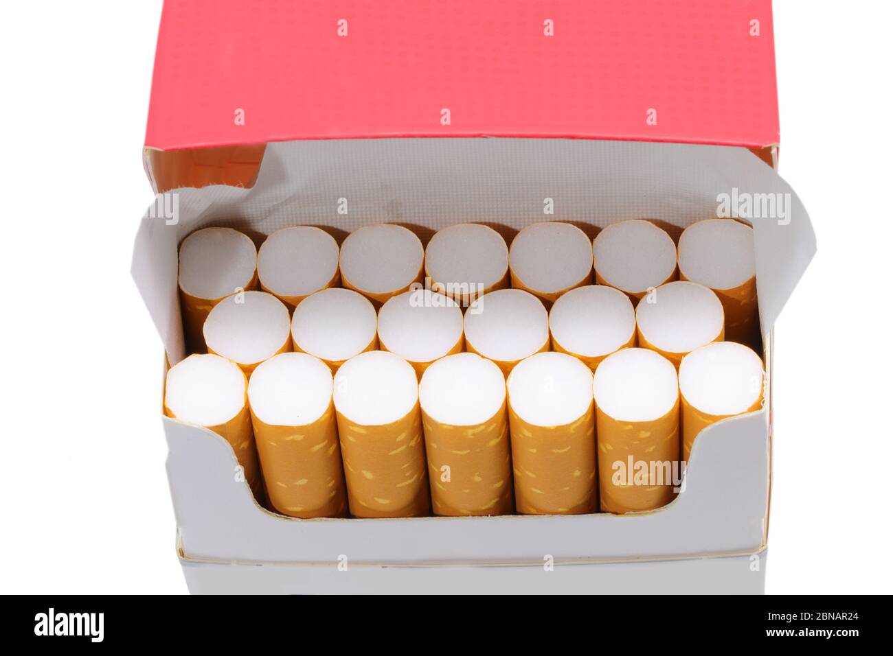 many filter cigarettes in a just opened package on a white background ...