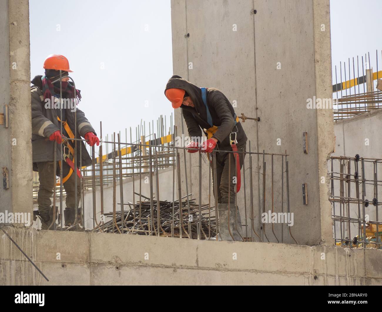 Construction workers collaborating in the installation fittings at a ...